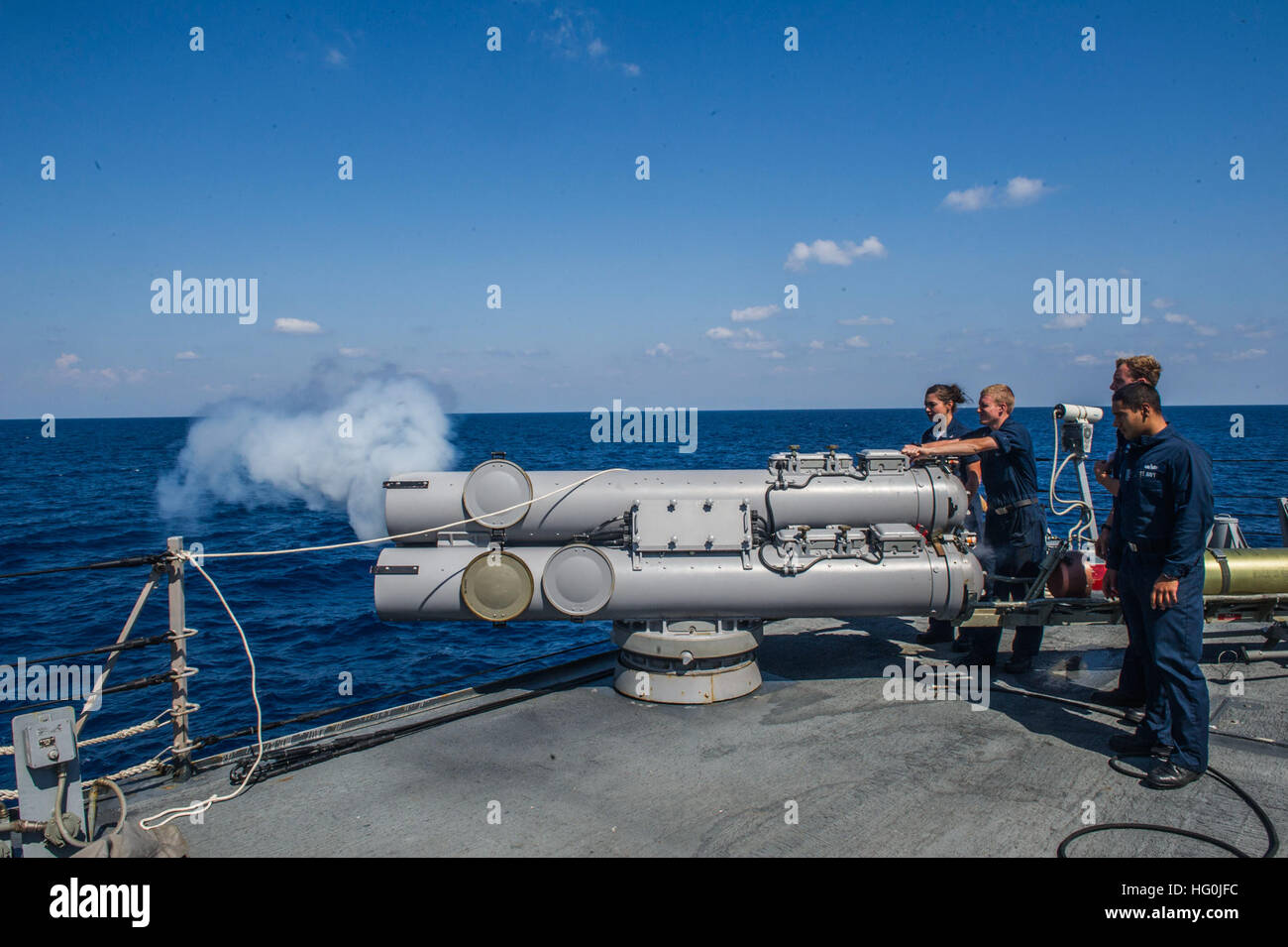 Sailors dry-fire a torpedo tube aboard the guided-missile destroyer USS ...
