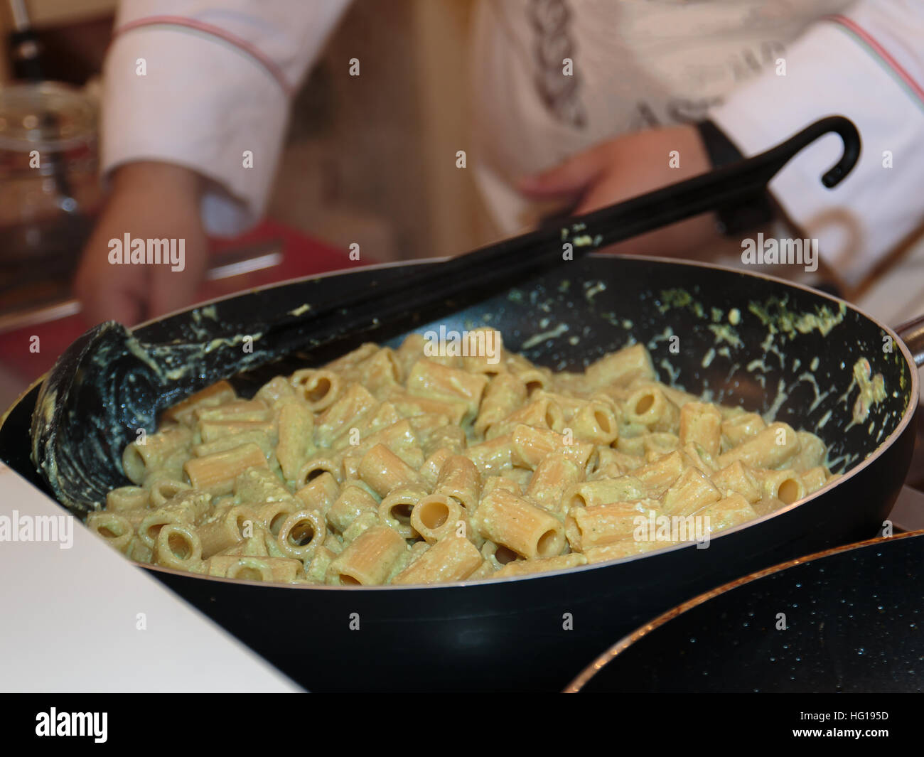 Cooking Tortiglioni al Pesto Italian Pasta in Pan Stock Photo - Alamy