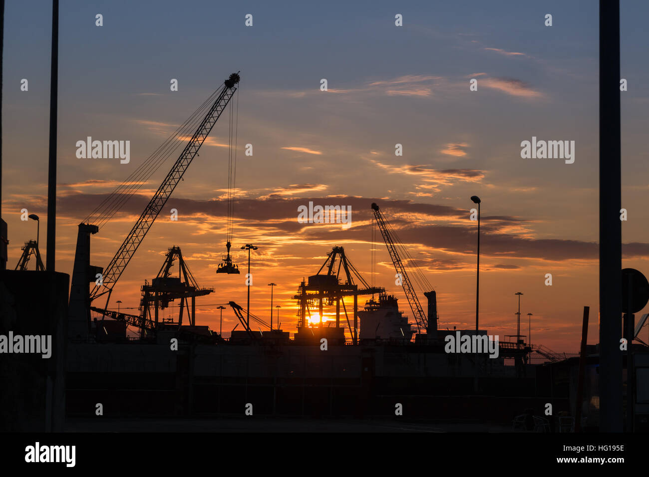 Silhouette of Cranes at Work in Boatyard at Sunset Stock Photo - Alamy
