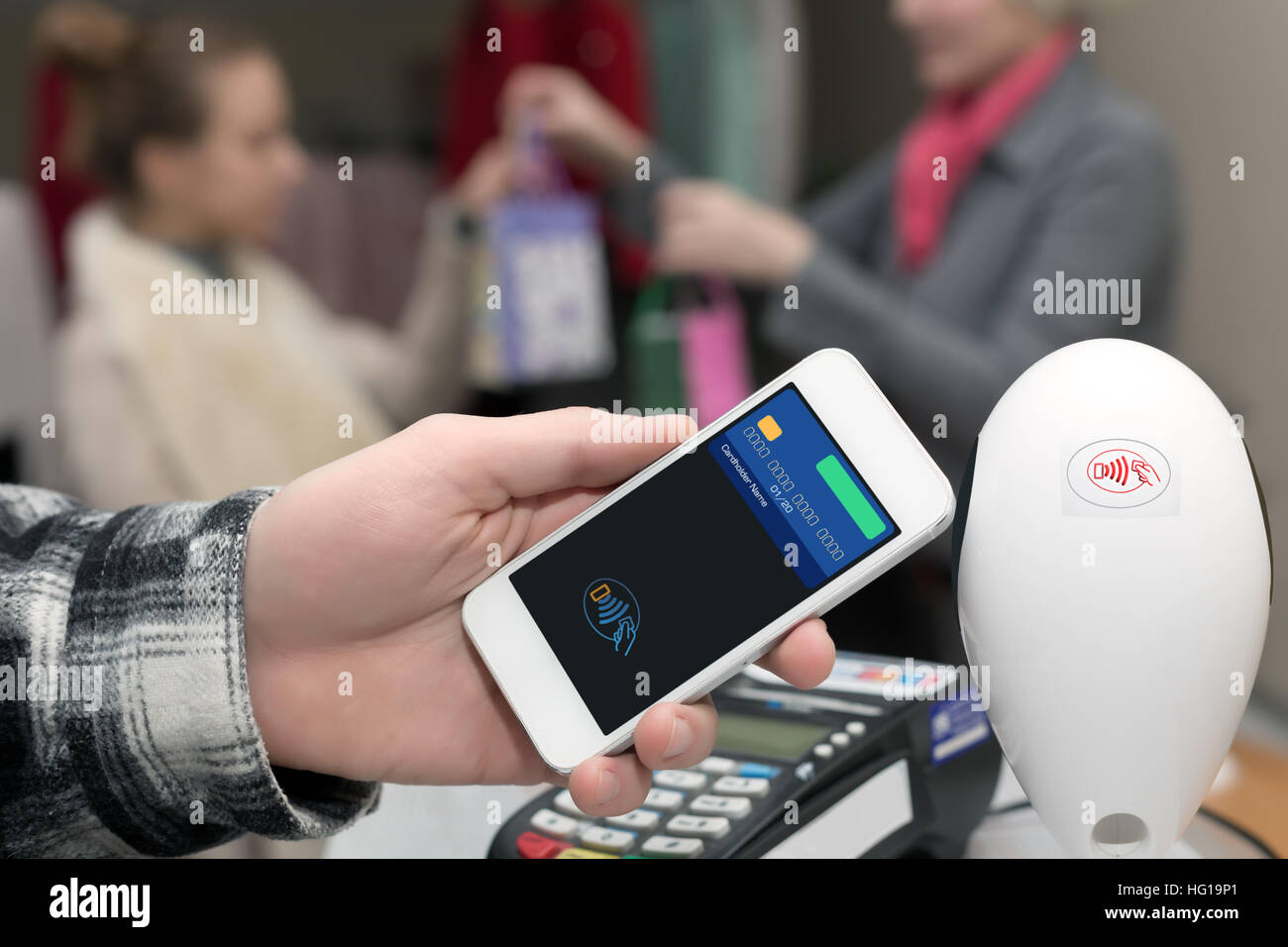 Man completing mobile Payment at Store Cashiers Desk with Terminal ...