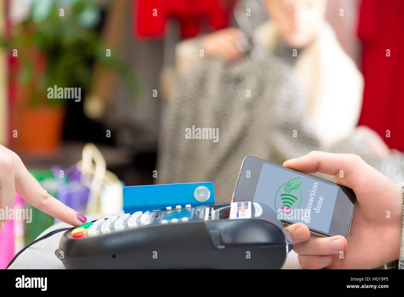 Man completing mobile Payment at Store Cashiers Desk with Terminal ...