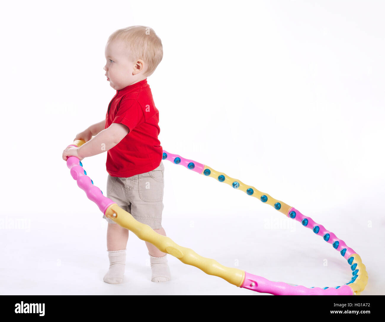 beautiful funny child plays with hoop Stock Photo - Alamy