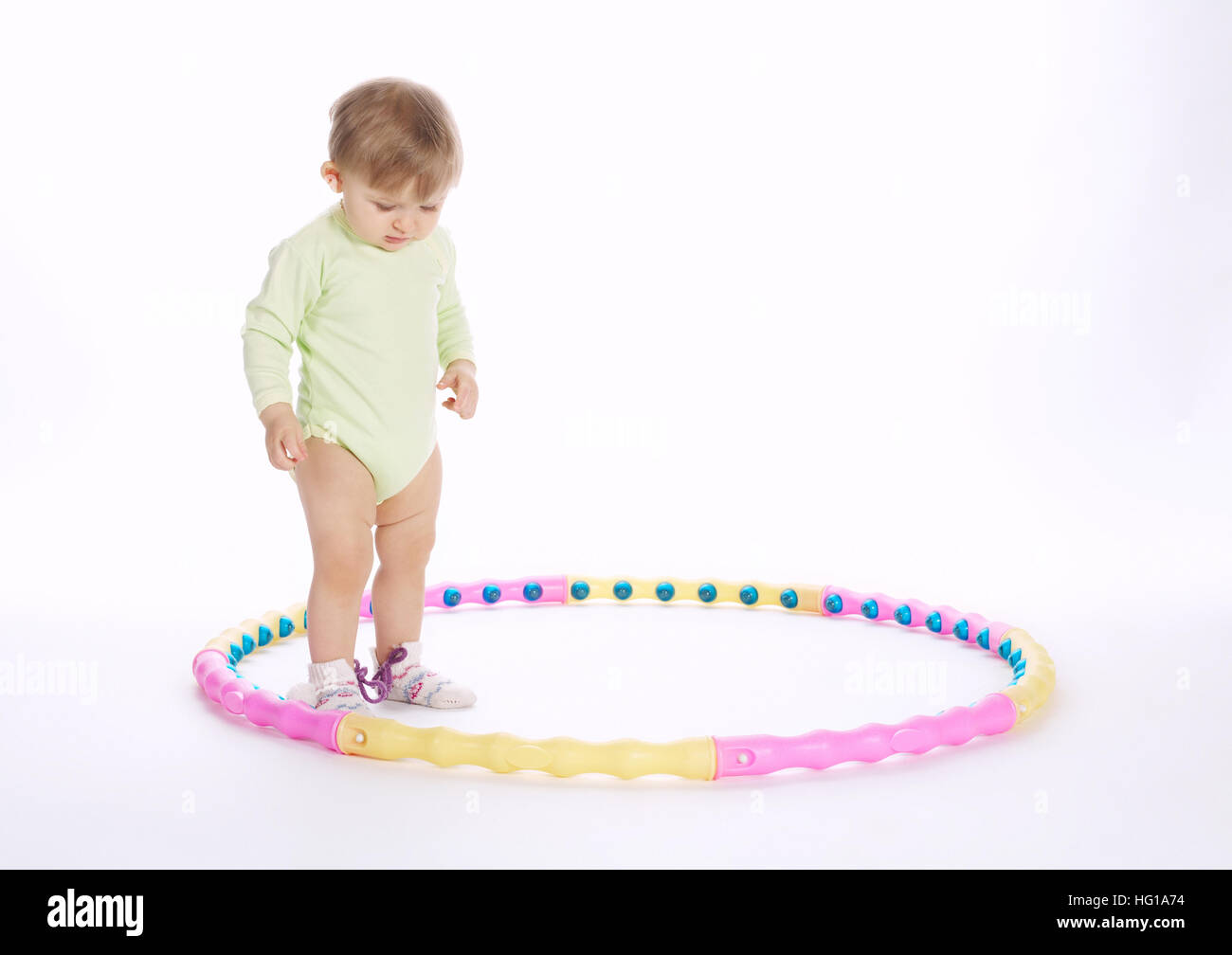 beautiful funny child plays with hoop Stock Photo - Alamy