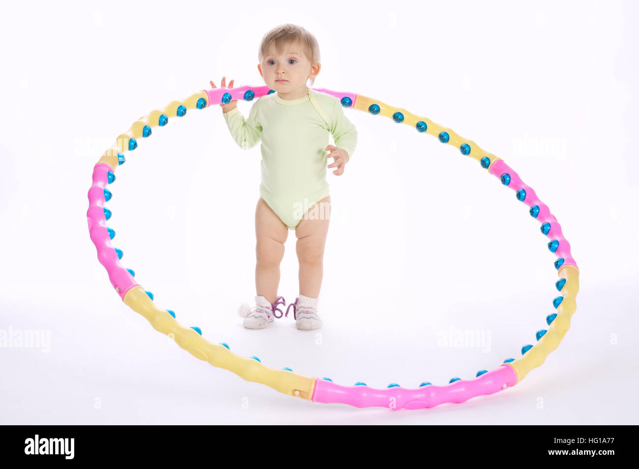 beautiful funny child plays with hoop Stock Photo - Alamy
