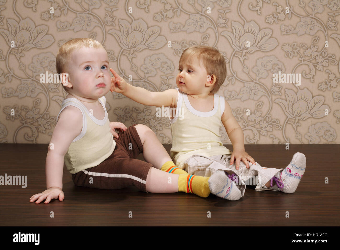 little girl touches boy with finger Stock Photo - Alamy
