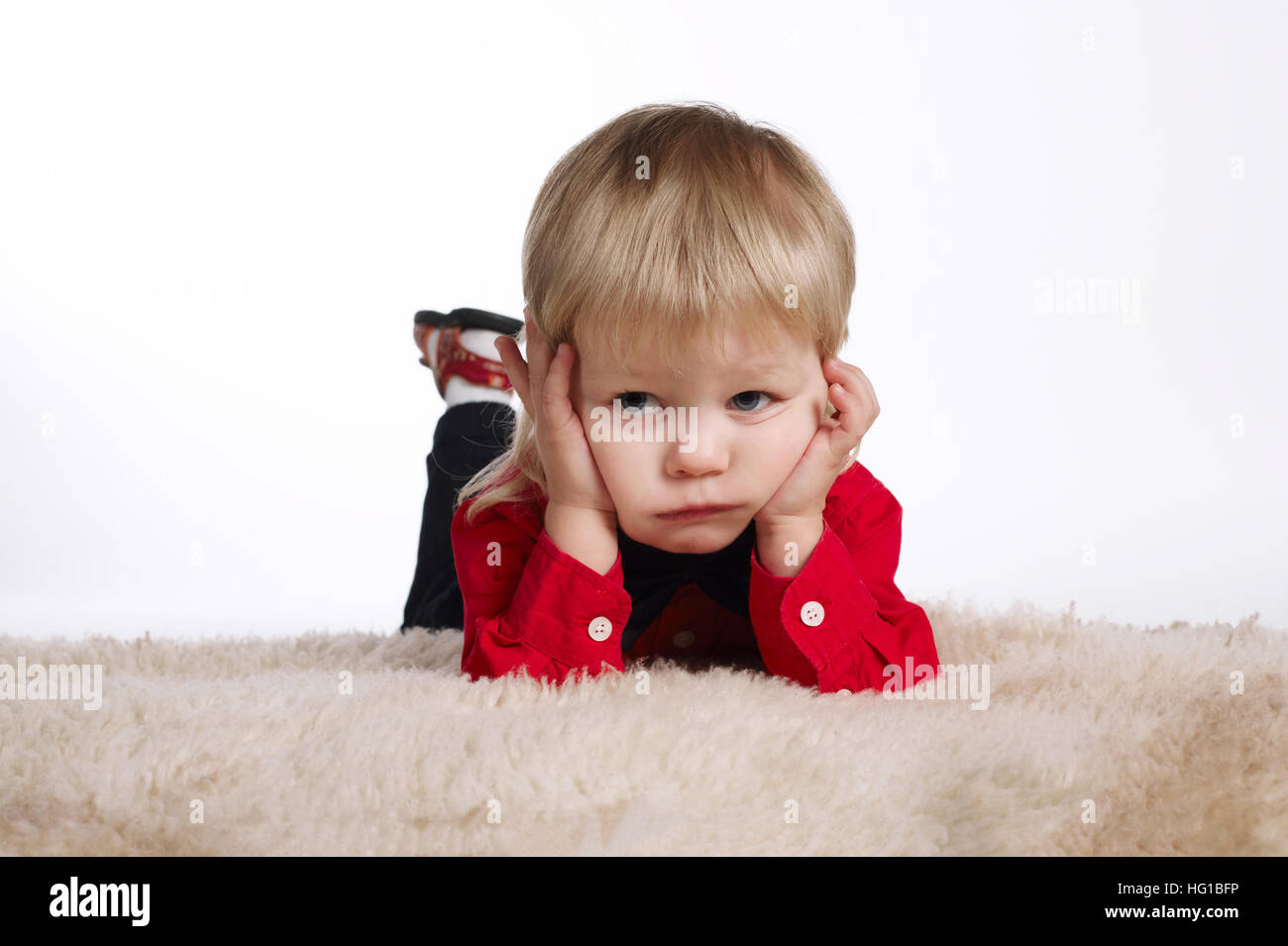 little bored boy on white background Stock Photo - Alamy