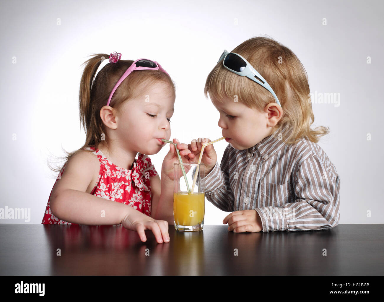 boy and girl drinking juice Stock Photo - Alamy