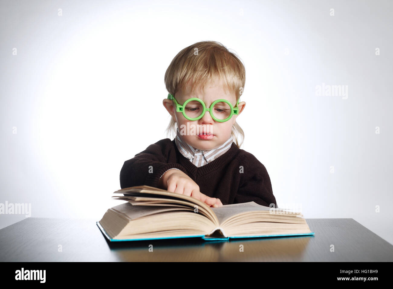 boy in funny glasses reading book on white Stock Photo - Alamy
