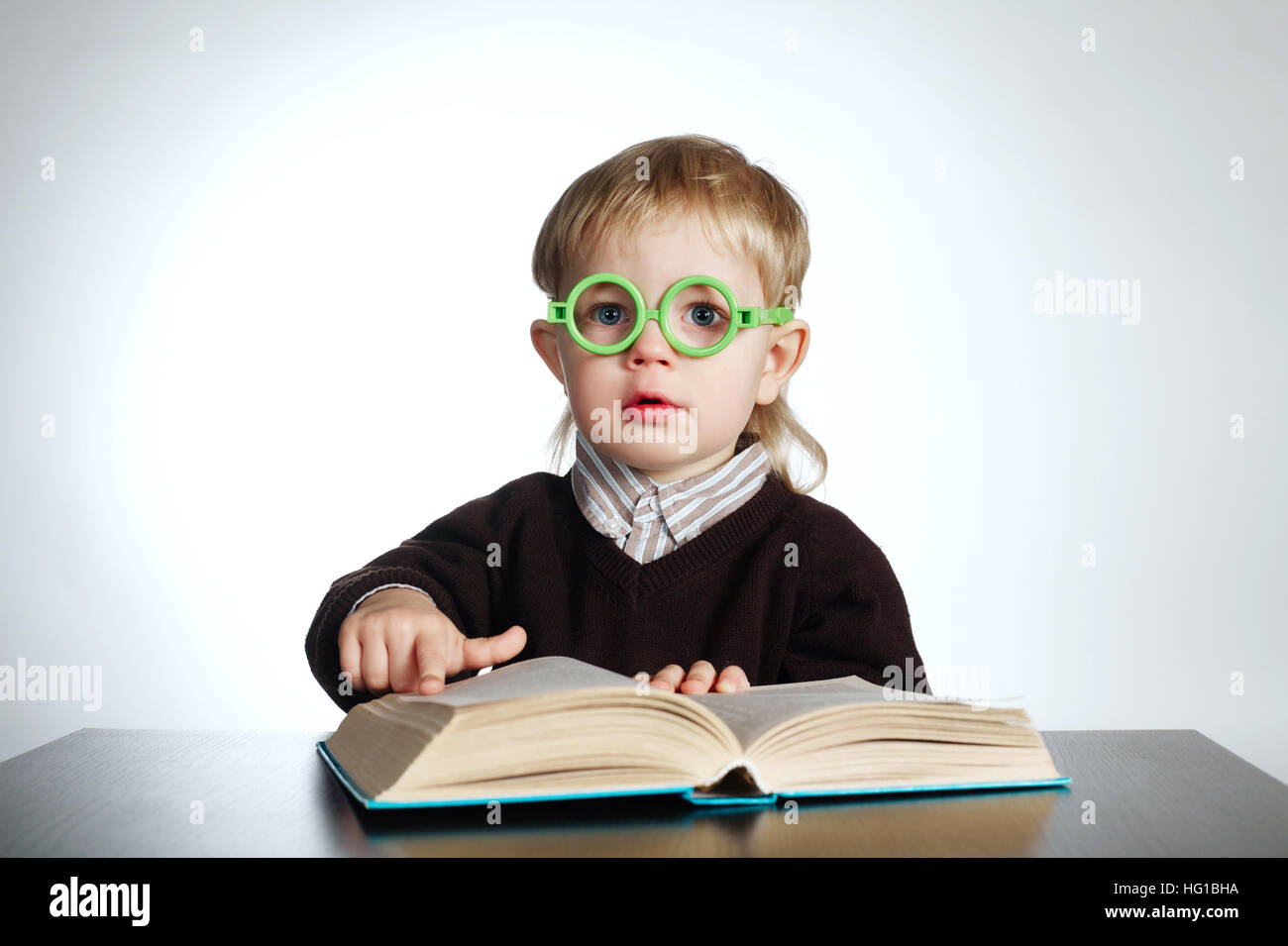 boy in funny glasses reading book on white Stock Photo - Alamy
