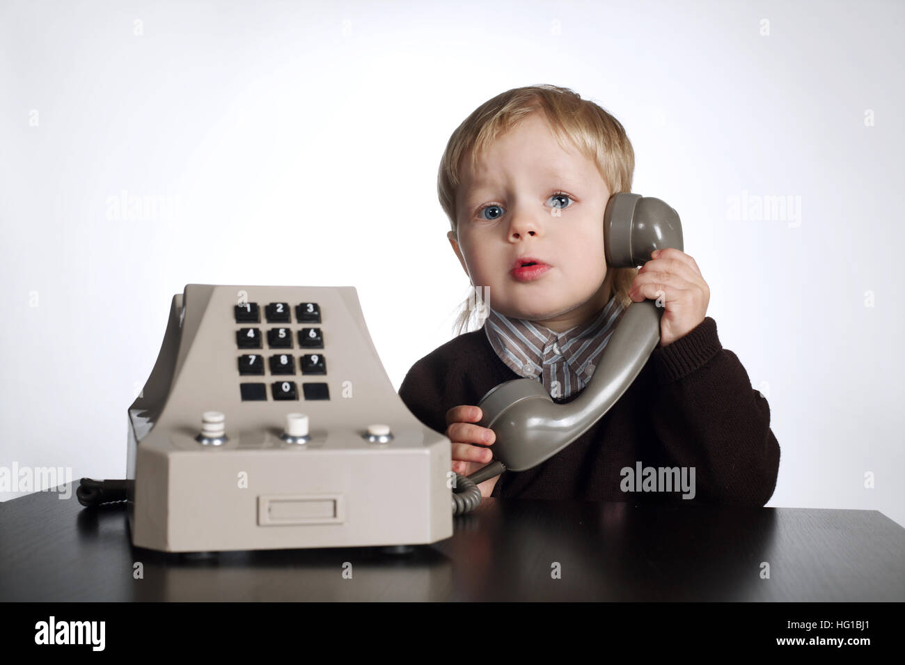 little boy using old phone Stock Photo - Alamy
