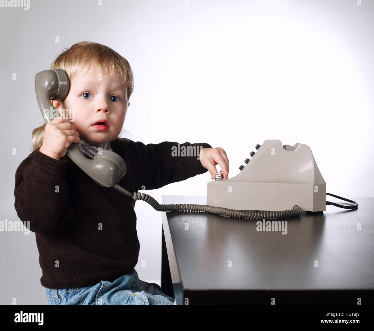little boy using old phone Stock Photo - Alamy
