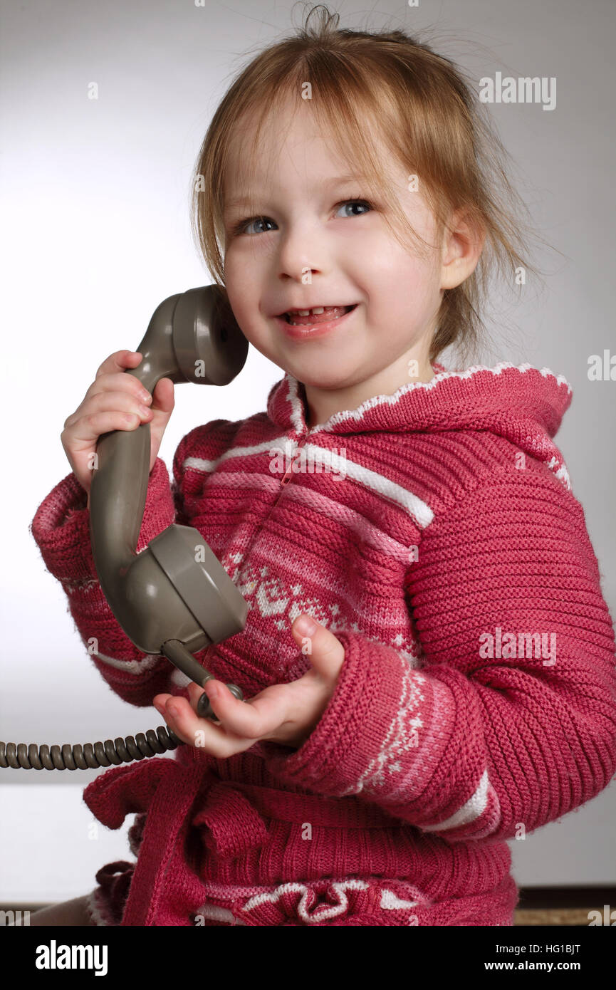 little girl using old phone Stock Photo - Alamy