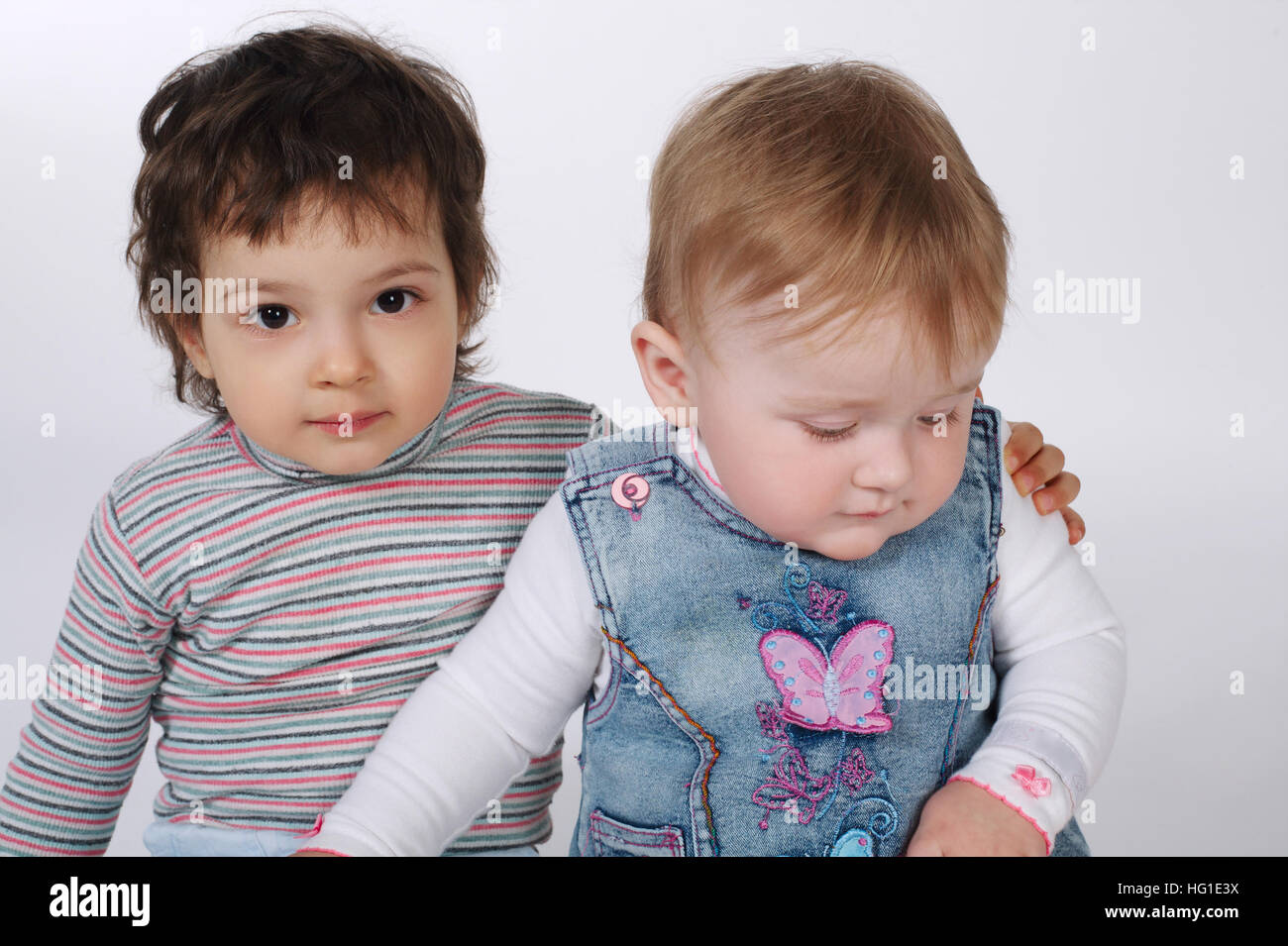 two cute hugging children on white Stock Photo - Alamy