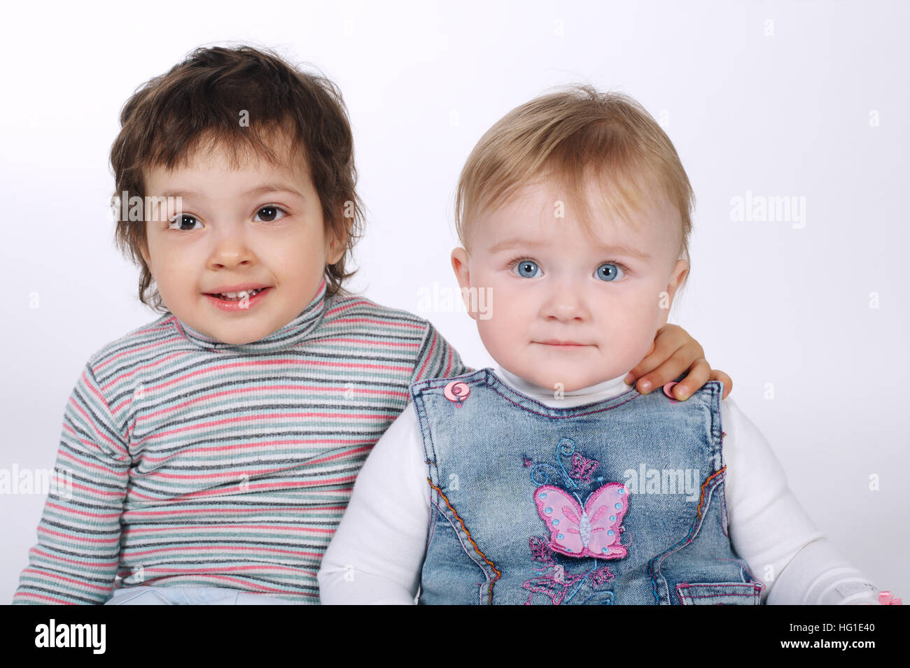 two cute hugging children on white Stock Photo - Alamy