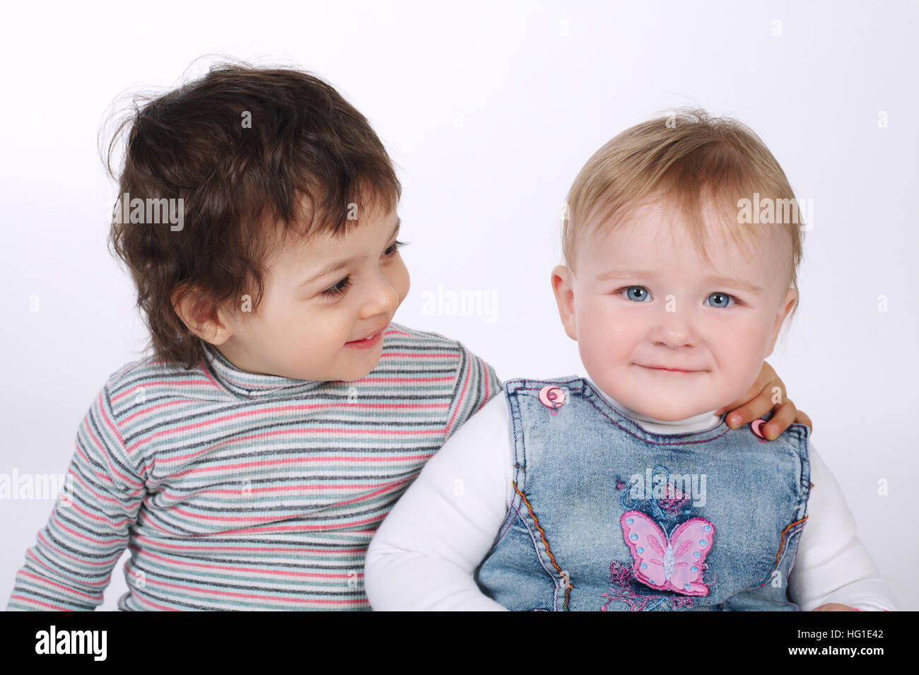 two cute hugging children on white Stock Photo - Alamy