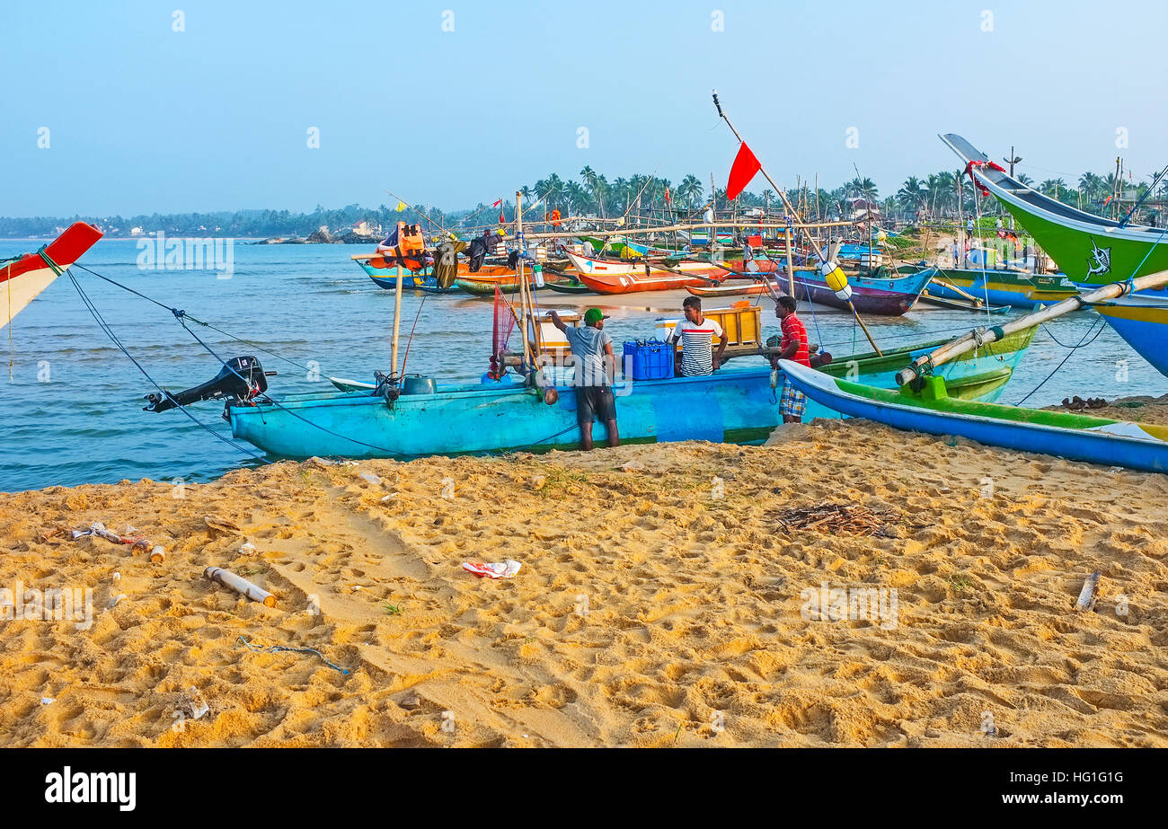 The fishermen moor the boat at the old fishing harbor Stock Photo - Alamy