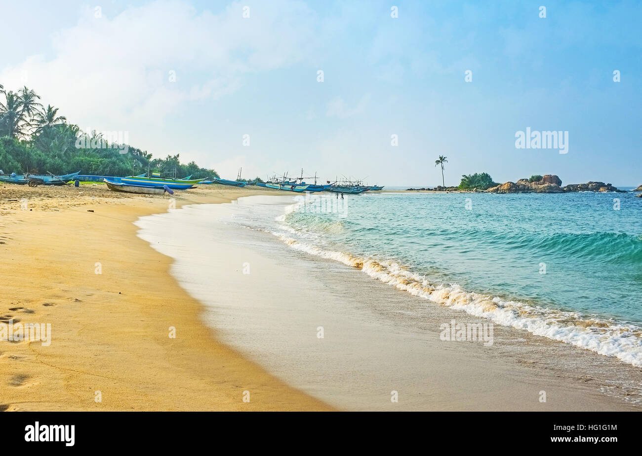 The walk along the beautiful sandy beach with the fishing boats ...