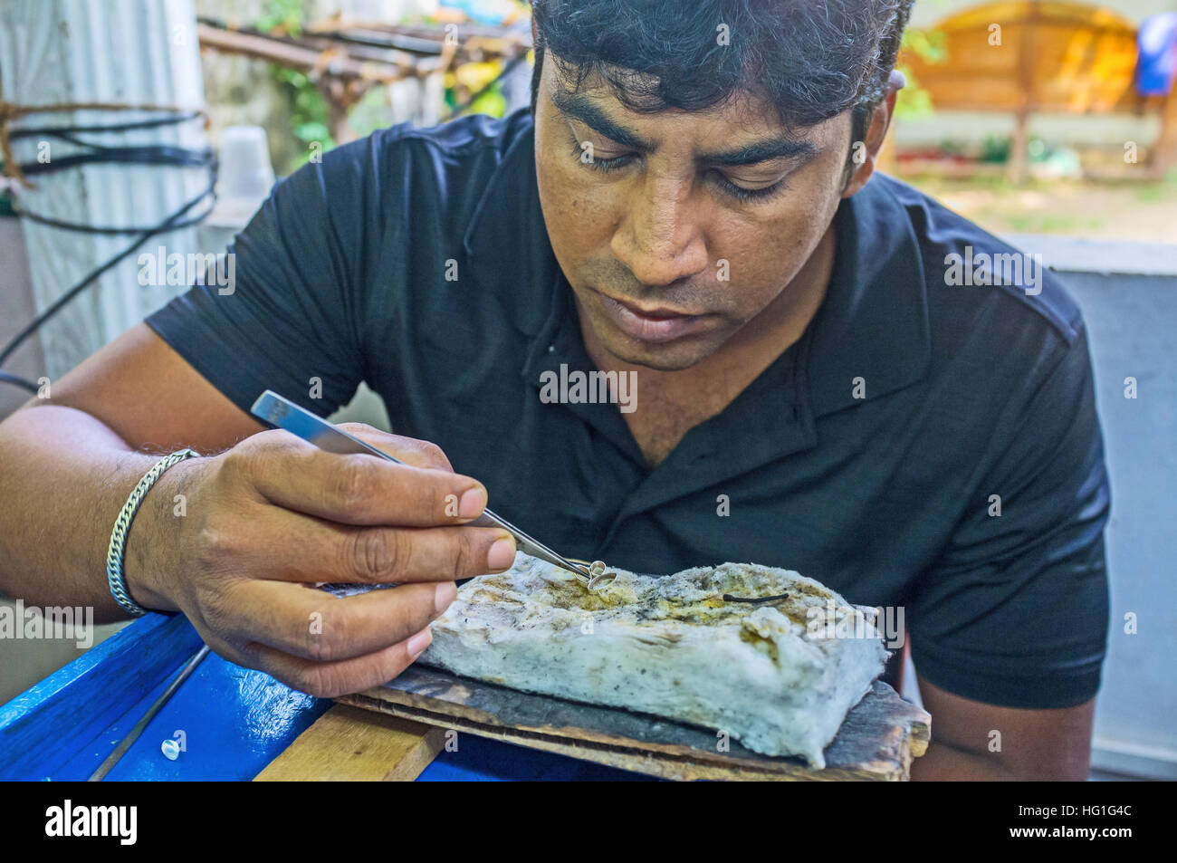 The silversmith lat his work, producing the jewelry base Stock Photo ...