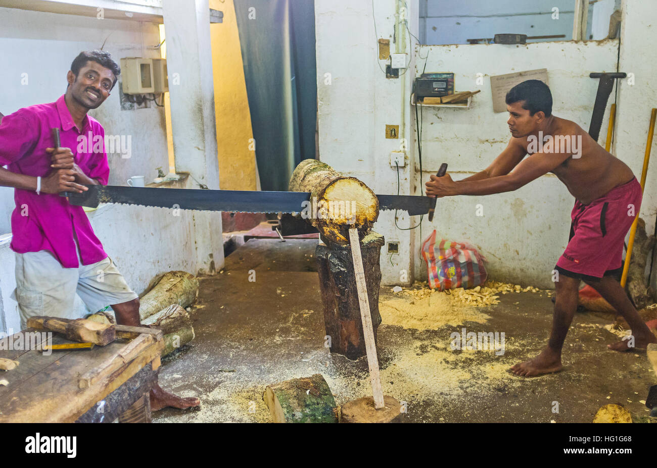 The masters cut the tree trunk for the mask bases in workshop of the ...
