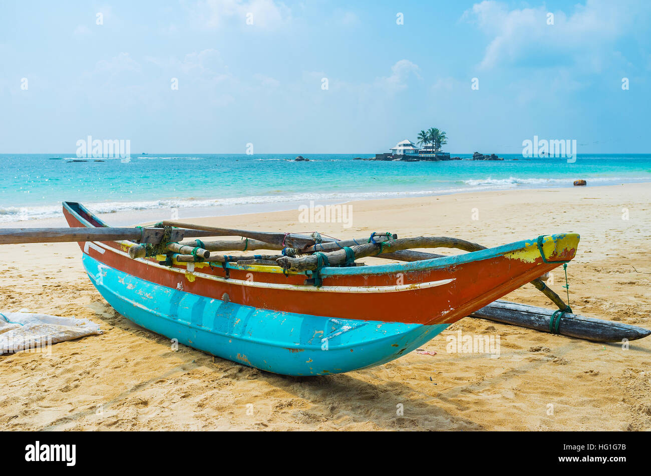 The old catamaran boat on the beach next to the island of Seenigama ...