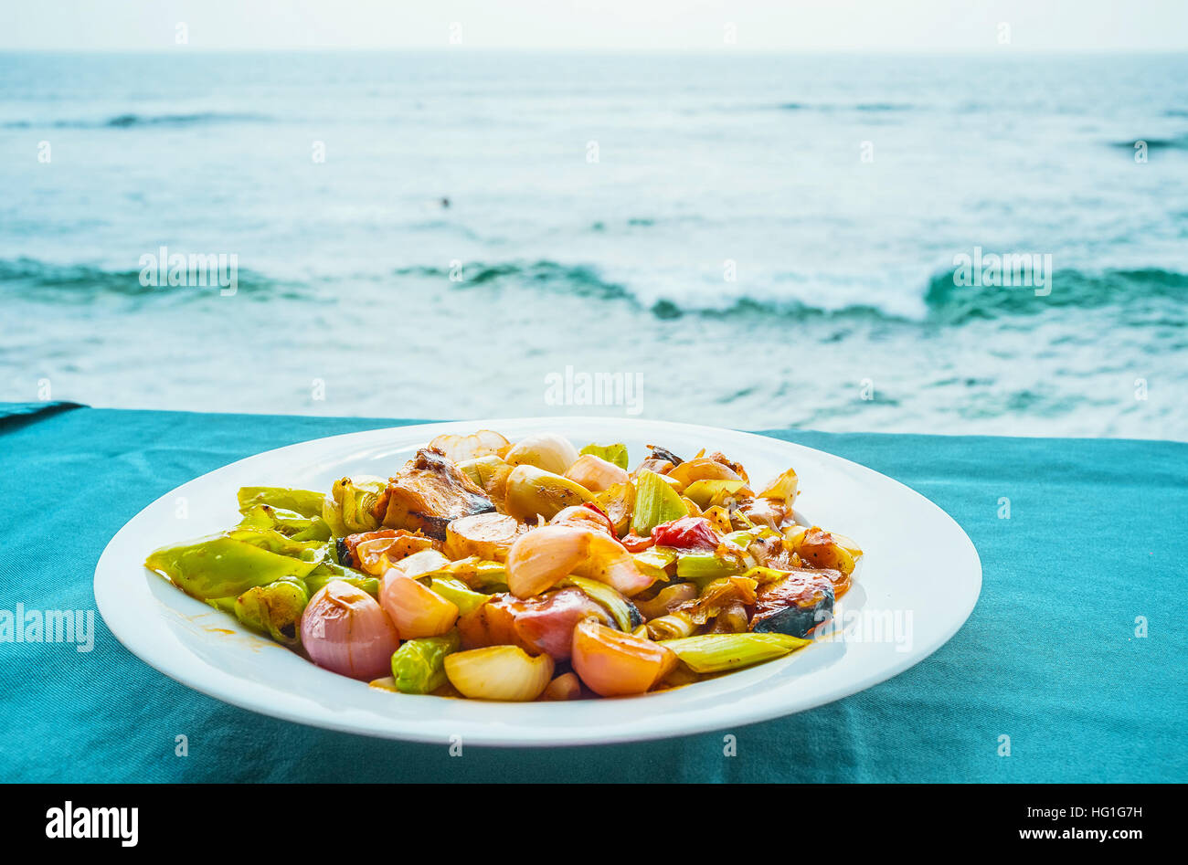 The tasty deviled fish with stewed vegetables on the restaurant's table ...