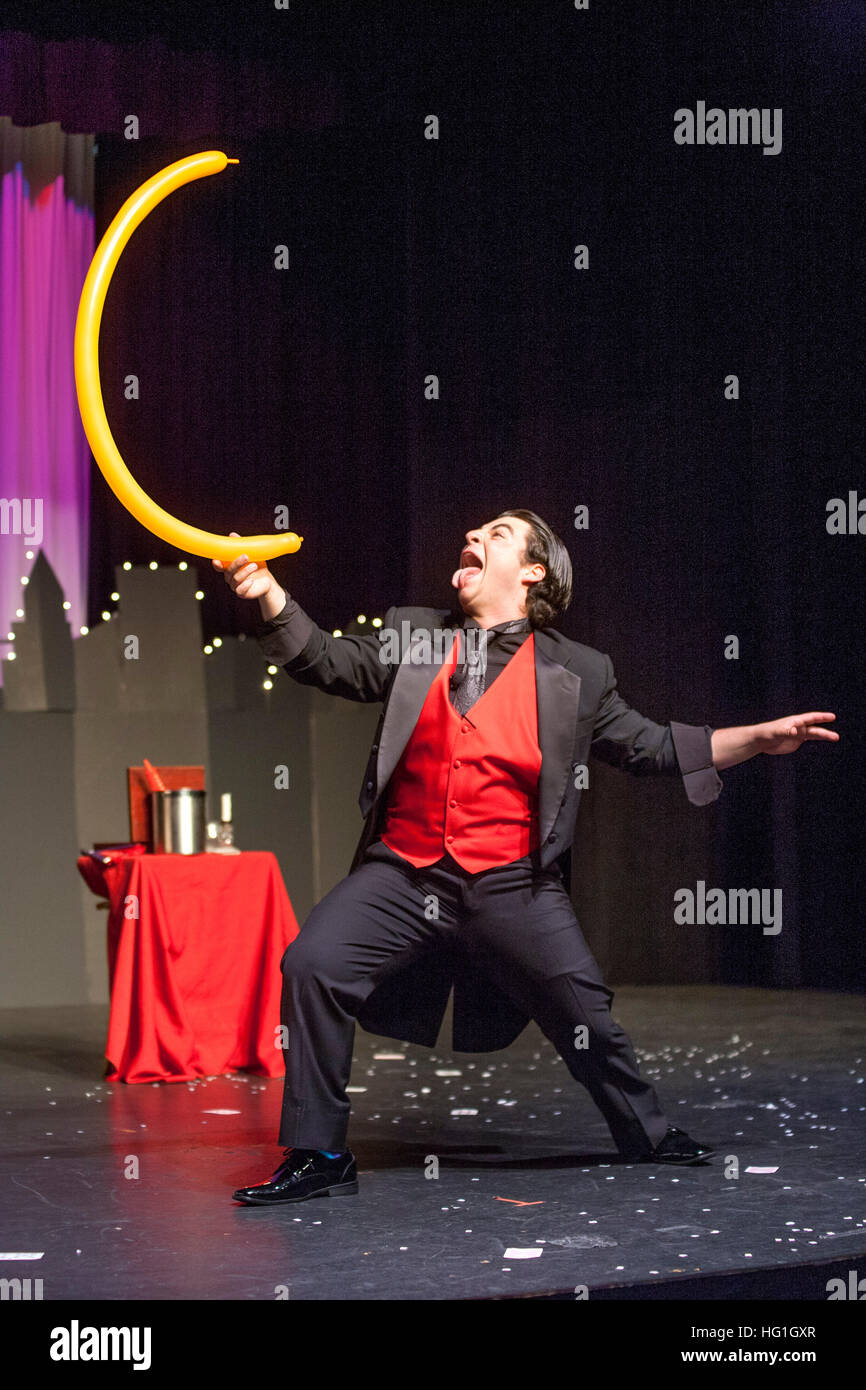 A formally dressed magician sticks out his tongue as he prepares to eat ...