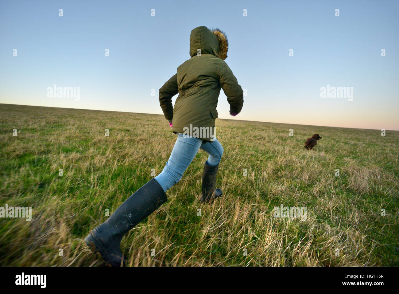 Child running after dog hi-res stock photography and images - Alamy