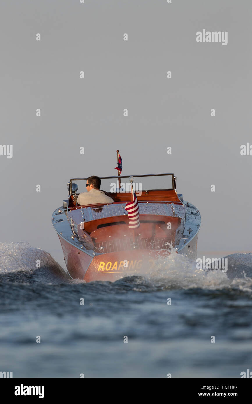 A man driving away in an antique, wooden speedboat Stock Photo - Alamy