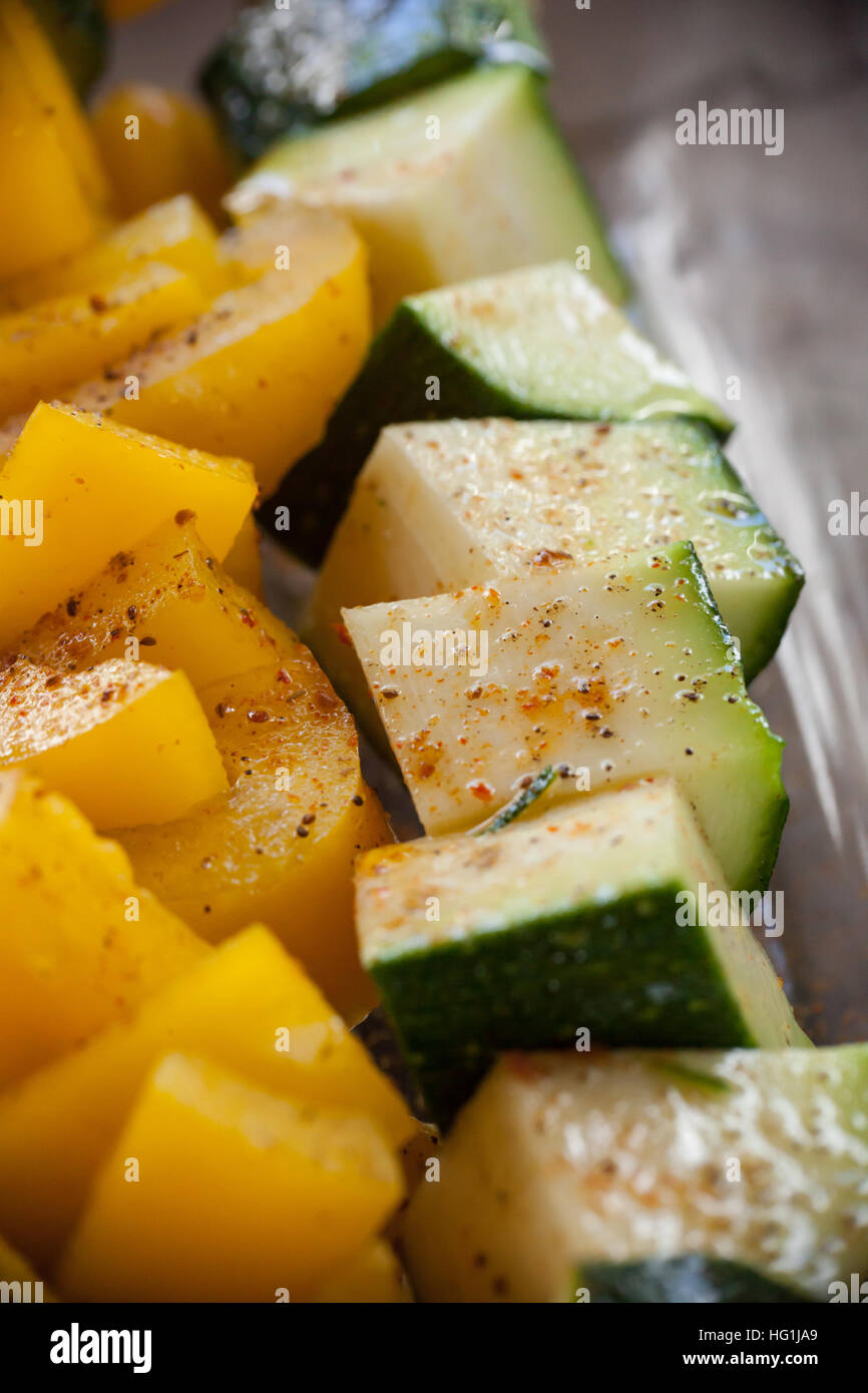 Brightly colored zucchini and orange bell pepper kebabs are raw and ...