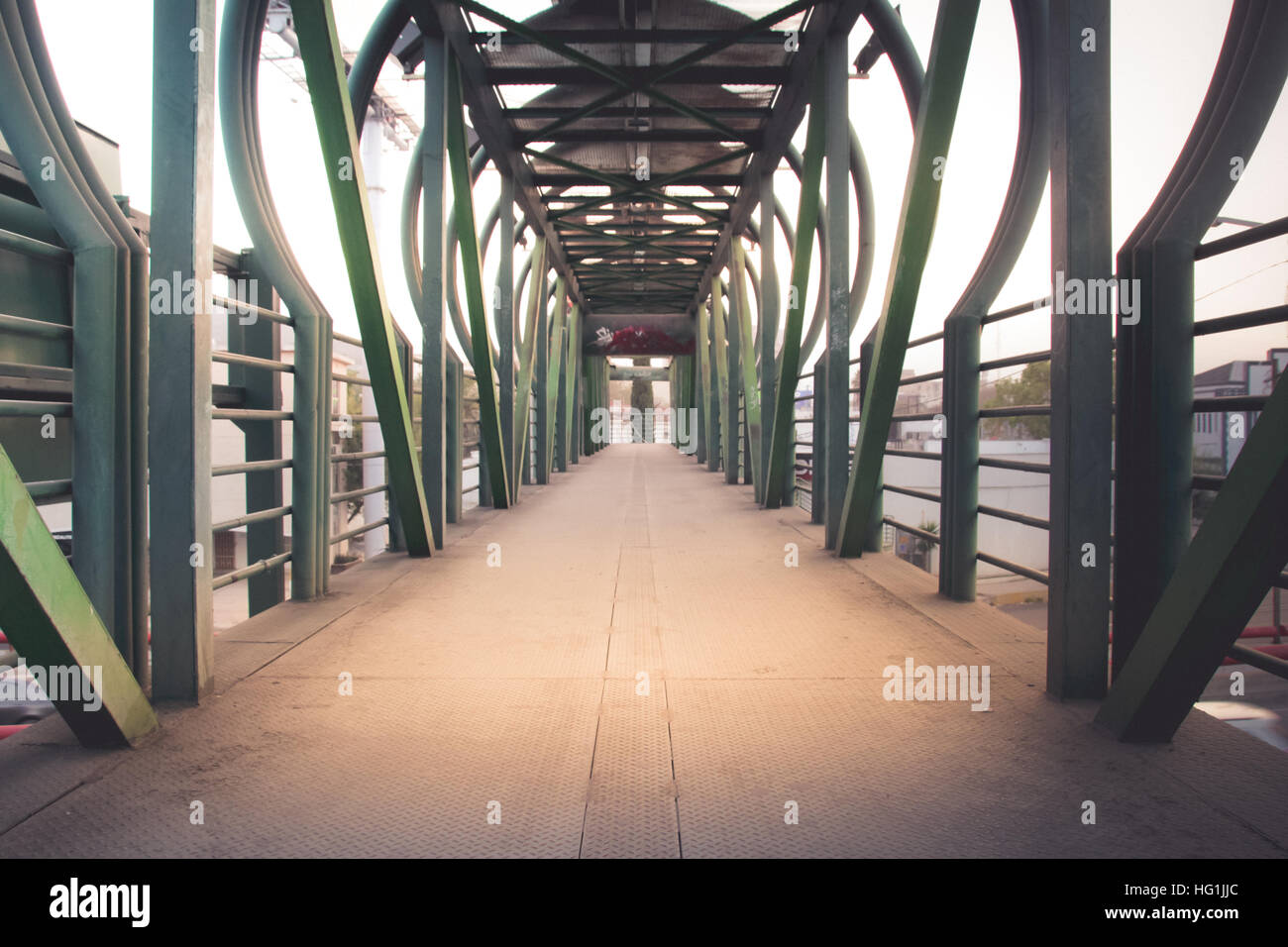 Photograph of a metal pedestrian bridge Stock Photo - Alamy
