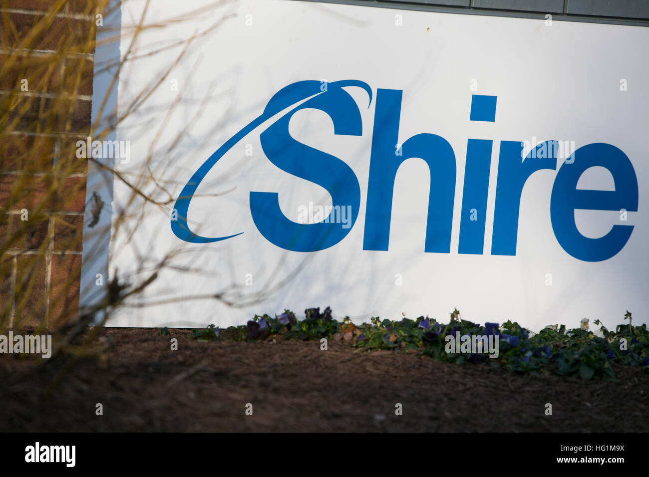A logo sign outside of a facility occupied by Shire Plc in Exton ...