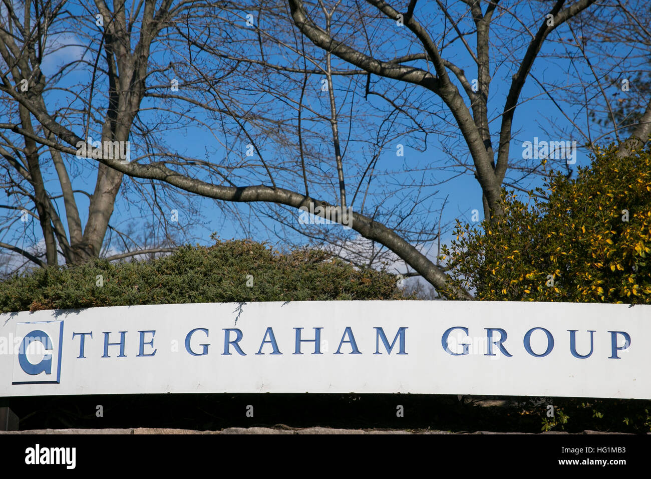 A logo sign outside of a facility occupied by The Graham Group in ...