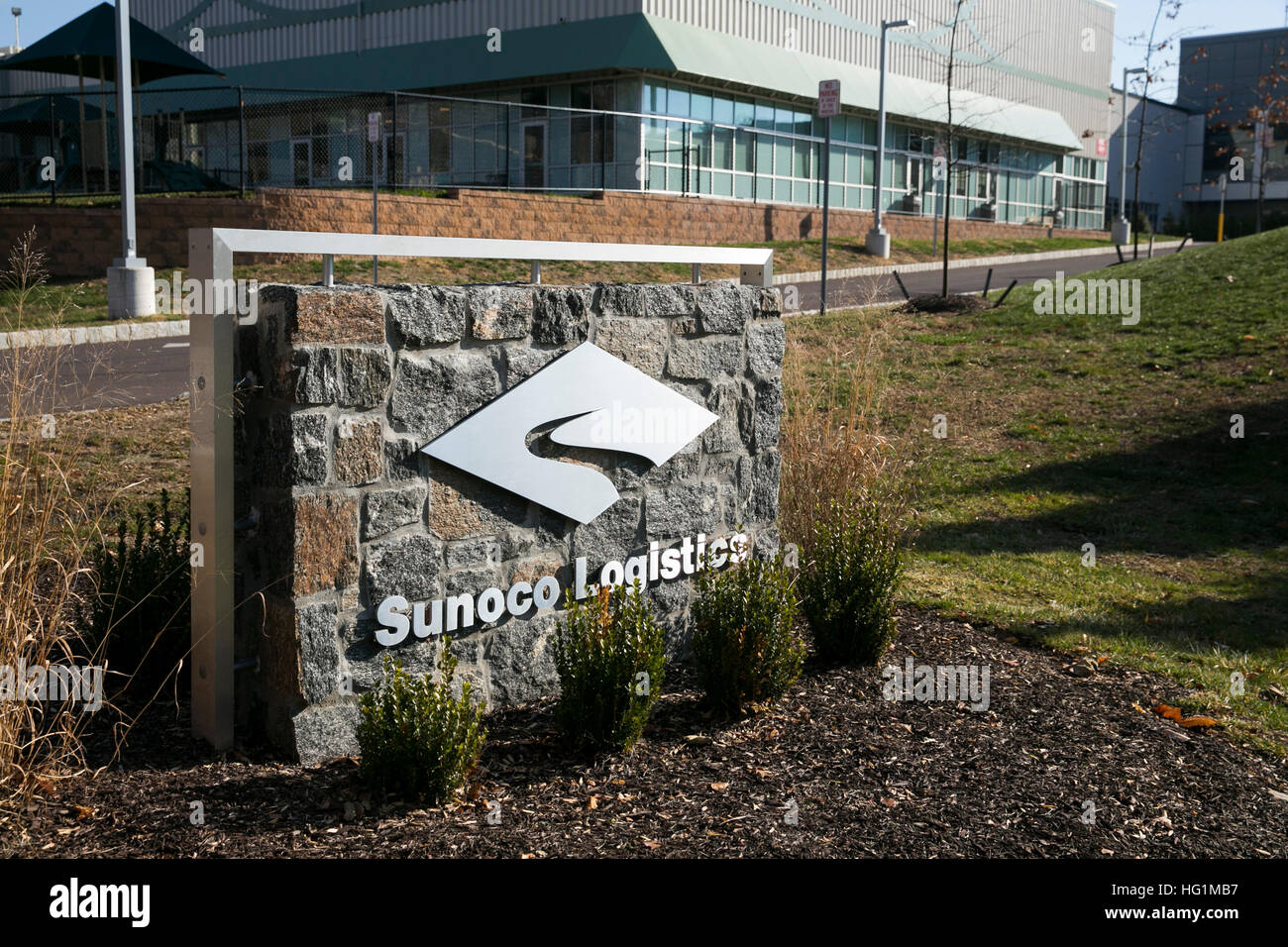 A logo sign outside of a facility occupied by Sunoco Logistics Partners ...