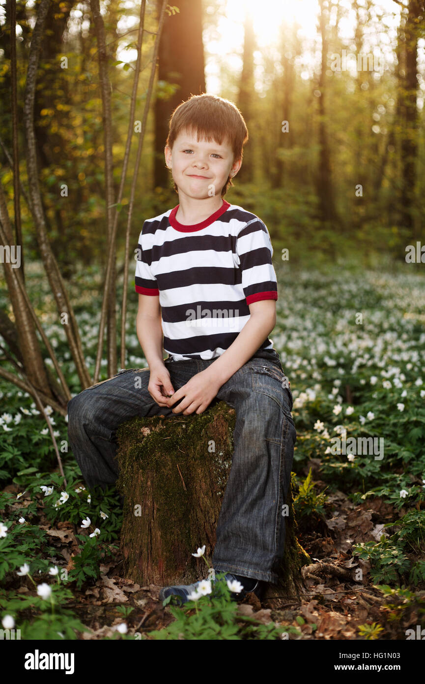 little boy in forest on flowers field Stock Photo - Alamy
