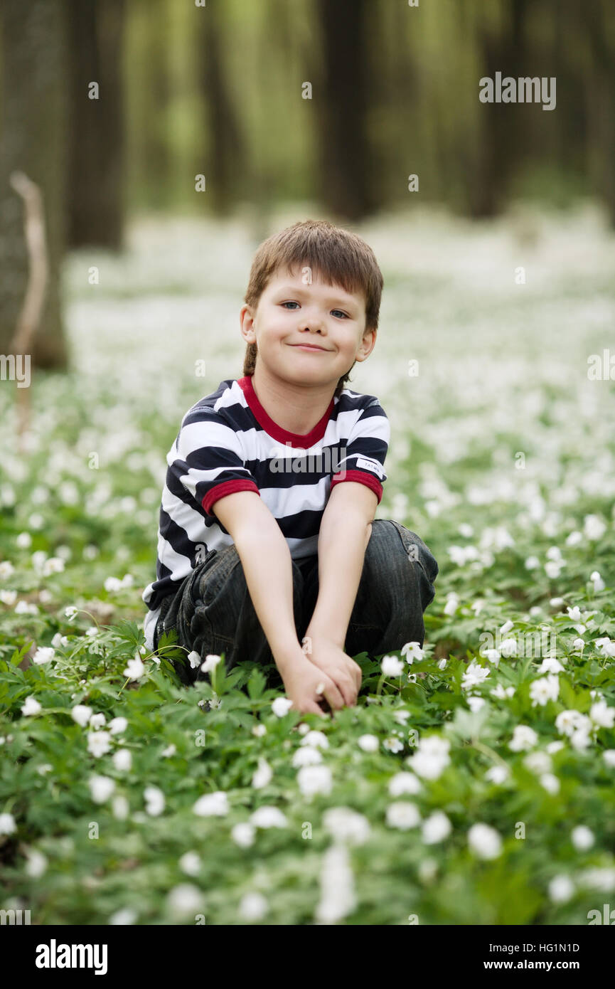 little boy in forest on flowers field Stock Photo - Alamy