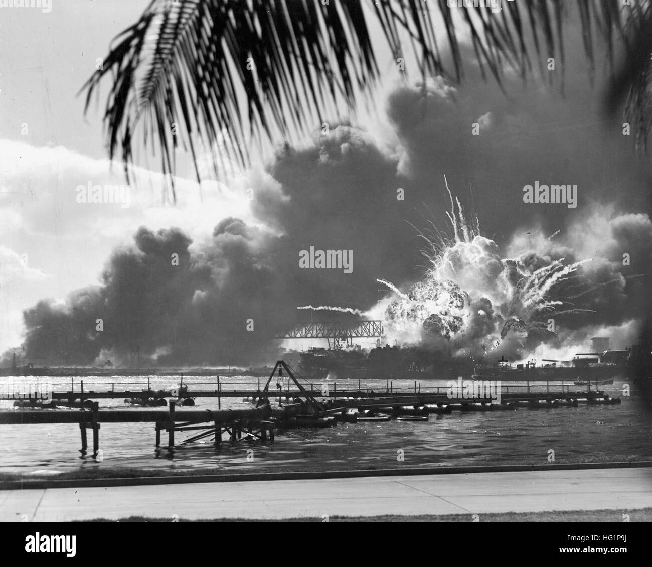 USS Shaw is depicted during the attack on Pearl Harbor, showing the ...