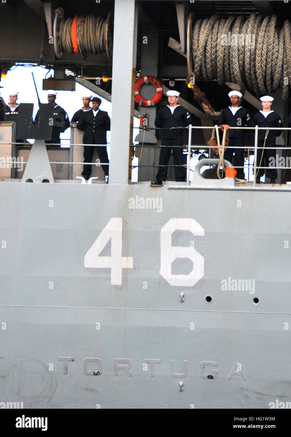 Sailors man the rails as the amphibious dock landing ship USS Tortuga ...