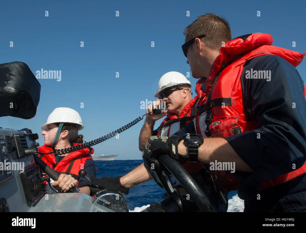 Chief Warrant Officer James Kechter, center, communicates with the ...