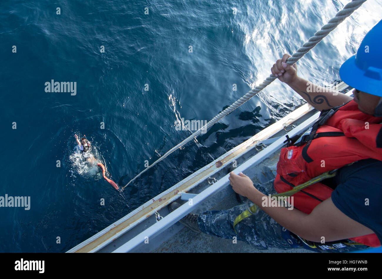 U.S. Navy Ensign Timothy McDaniel, left, a surface rescue swimmer ...