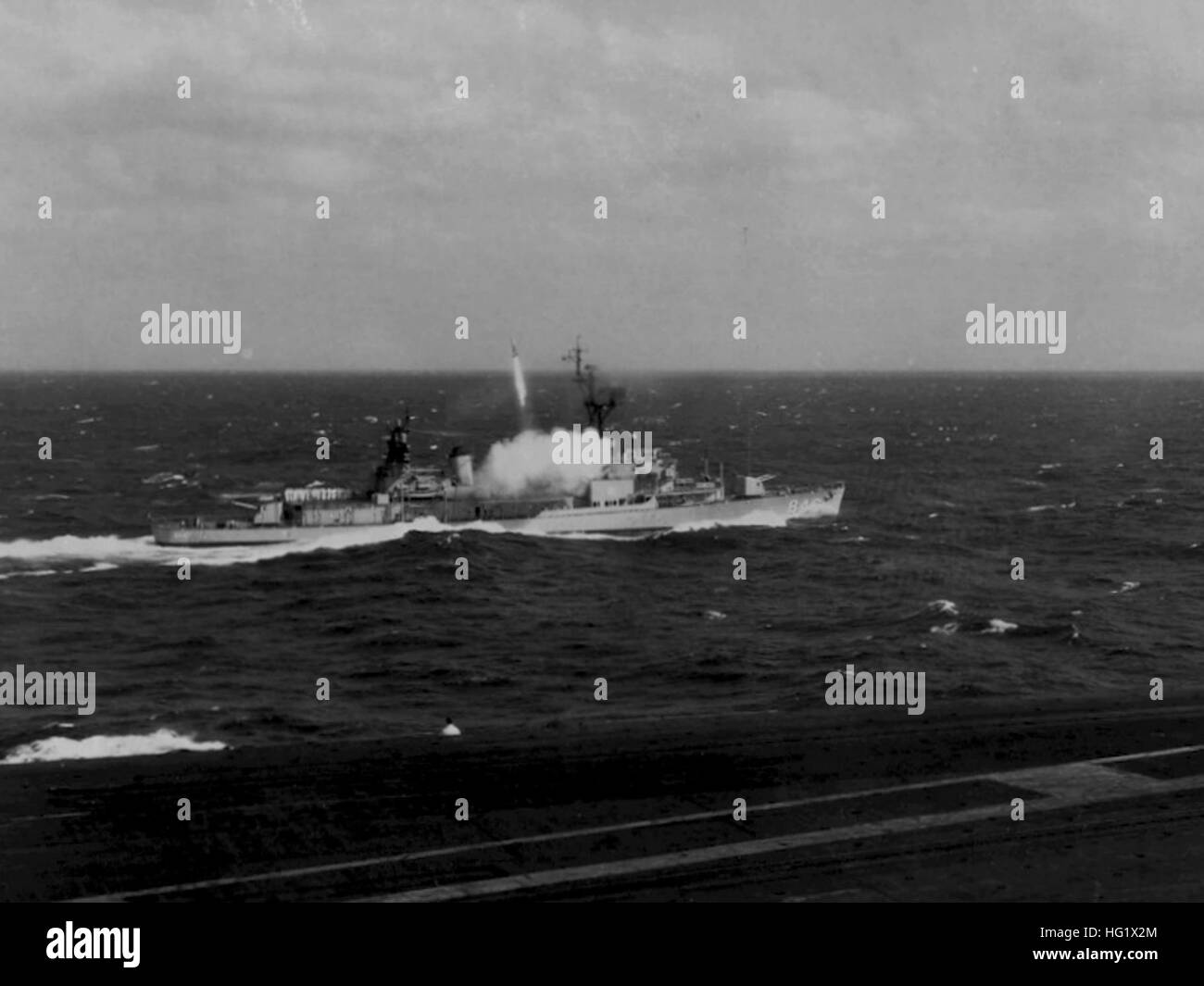 USS Ozbourn, a Gearing-class destroyer, launches an ASROC anti ...