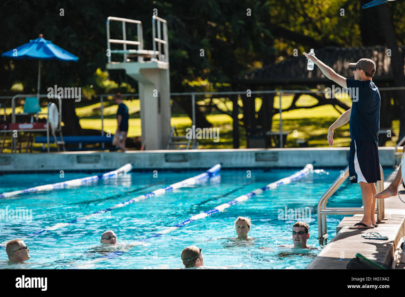 Members of Team Navy receive instructions from a coach during a swim ...