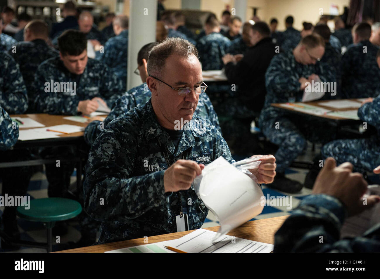 Interior Communications Electrician 1st Class James Duffy tears open a ...