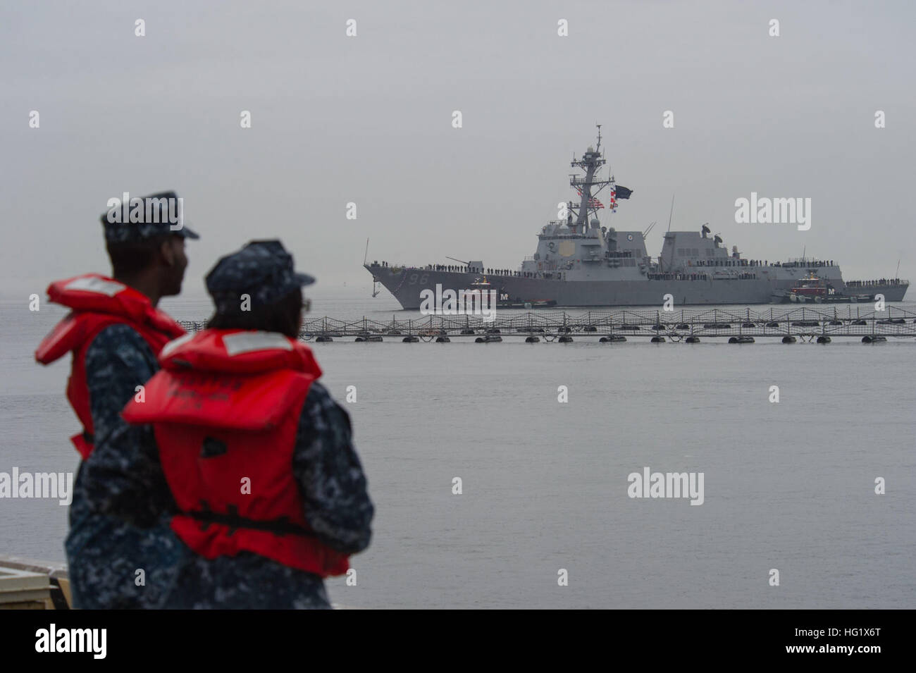 Sailors look on as Arleigh Burke-class guided-missile destroyer USS ...
