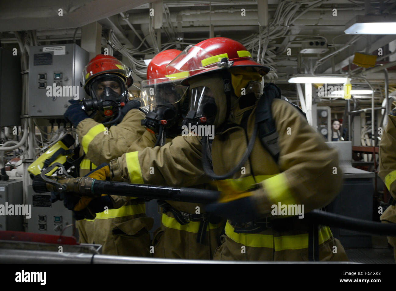 U.S. Sailors participate in a general quarters drill aboard the ...