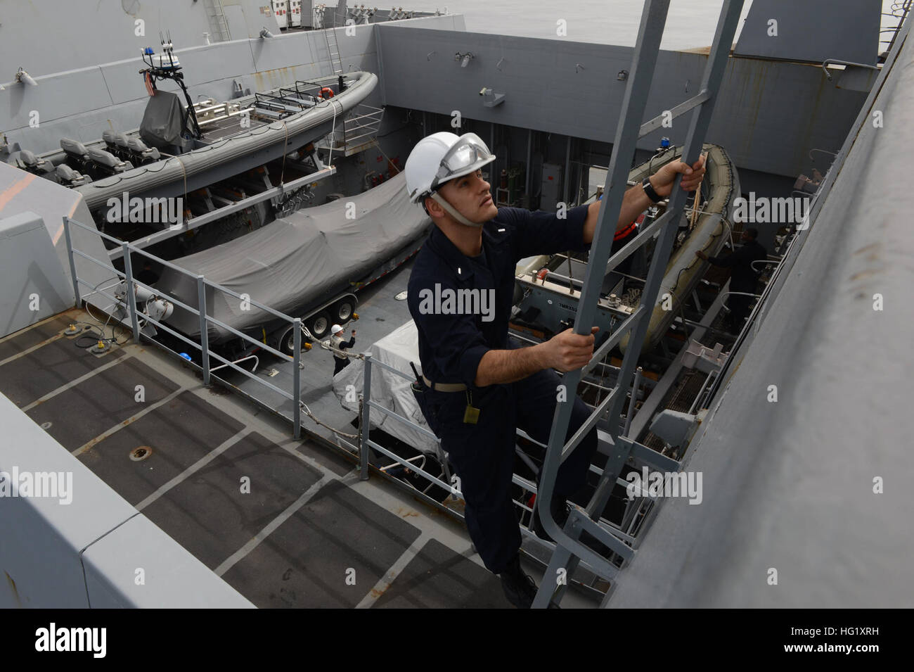 Lt. j.g. Victor Reza, from El Paso, Texas, climbs a ladder while ...