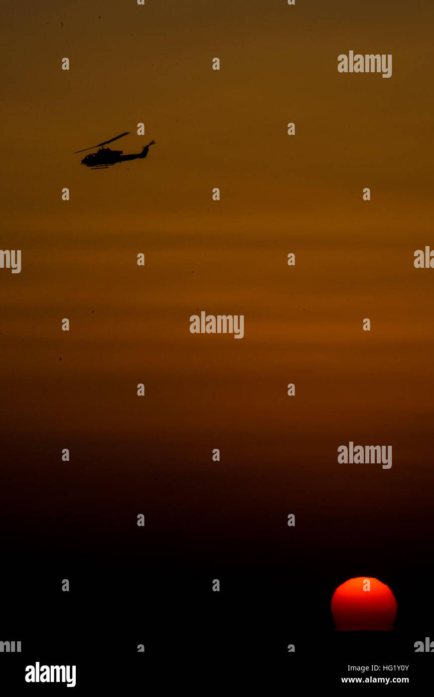 An AH-1W Super Cobra helicopter takes off from the amphibious dock ...