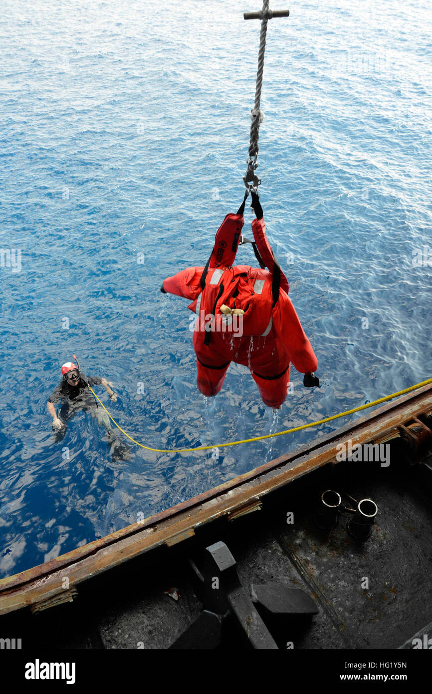 U.S. Navy Seaman Sonny Guzardo, a search and rescue swimmer, observes ...