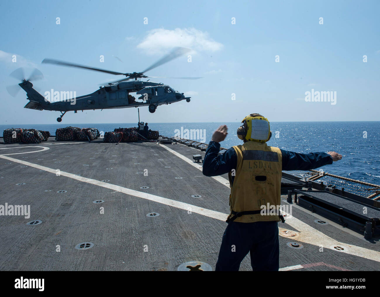 Boatswain's Mate directs MH-60S Sea Hawk helicopter to return ...