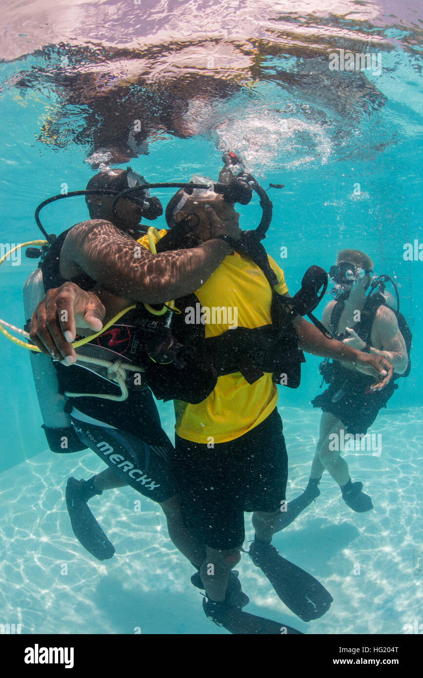 A Belize coast guard diver practices performing emergency procedures ...
