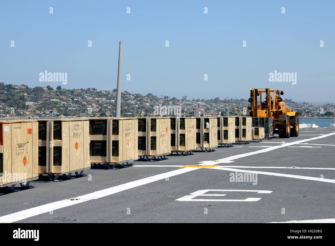 Gunner's Mate Seaman Apprentice Connor McLaughlin moves pallets to a ...